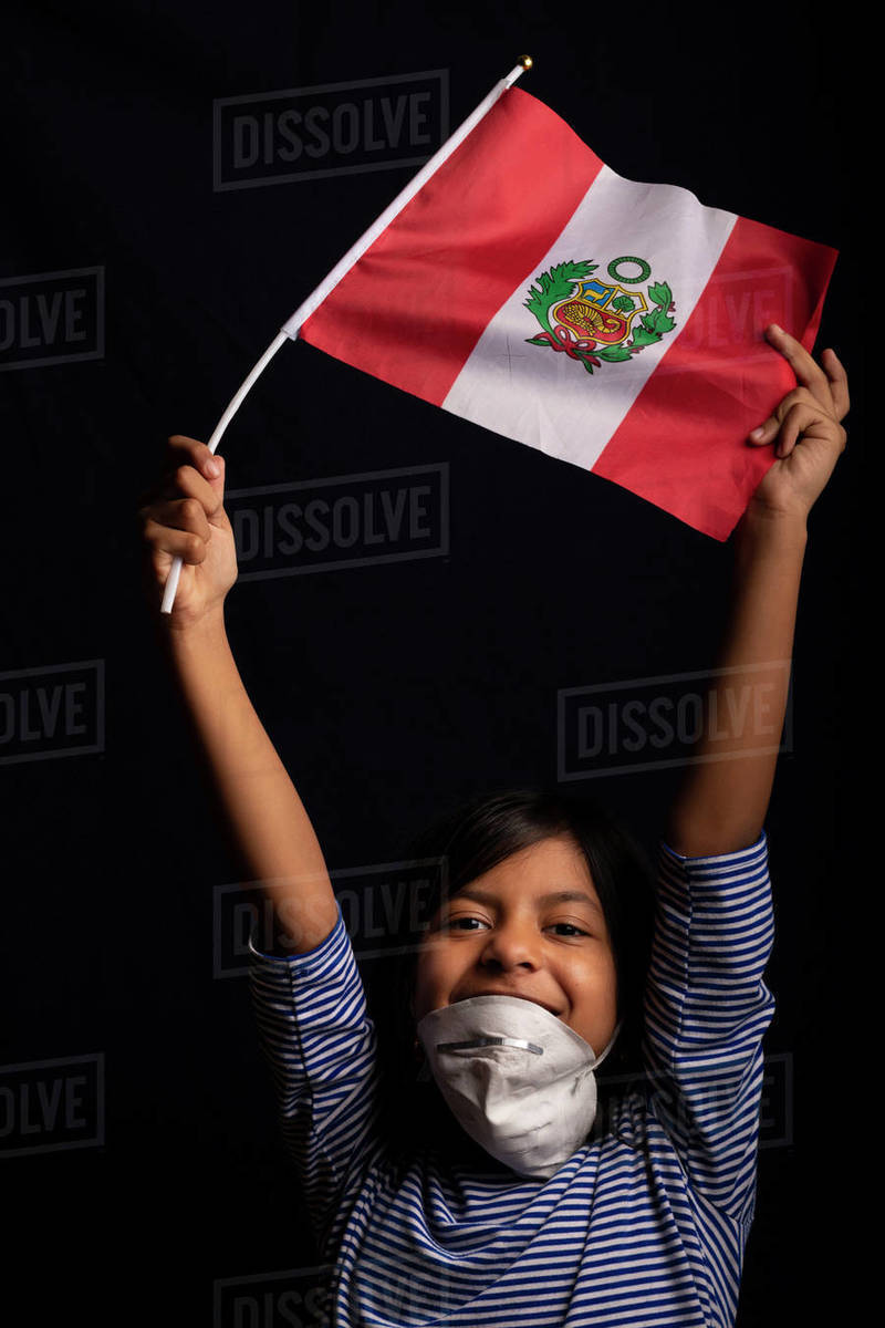 Portrait of little Peruvian girl wearing medical mask and holding ...