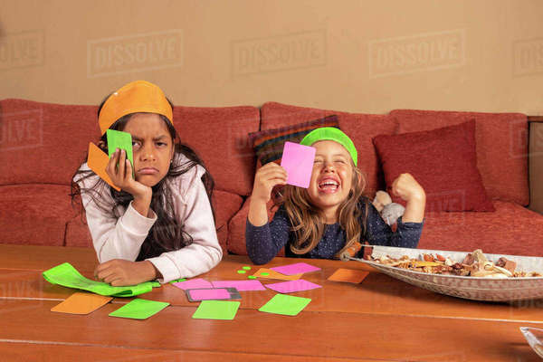 Girl celebrates after winning her card game - Stock Photo - Dissolve