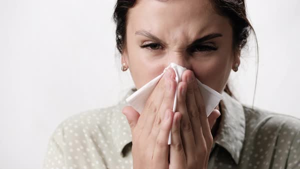 Nasal congestion, runny nose. Woman with cold and flu symptoms on white ...