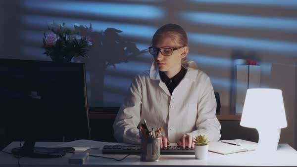 Smart female engineer working on computer and enjoying success in work ...