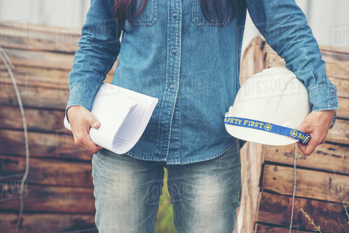Woman construction engineer wear safety white hard hat at construction ...