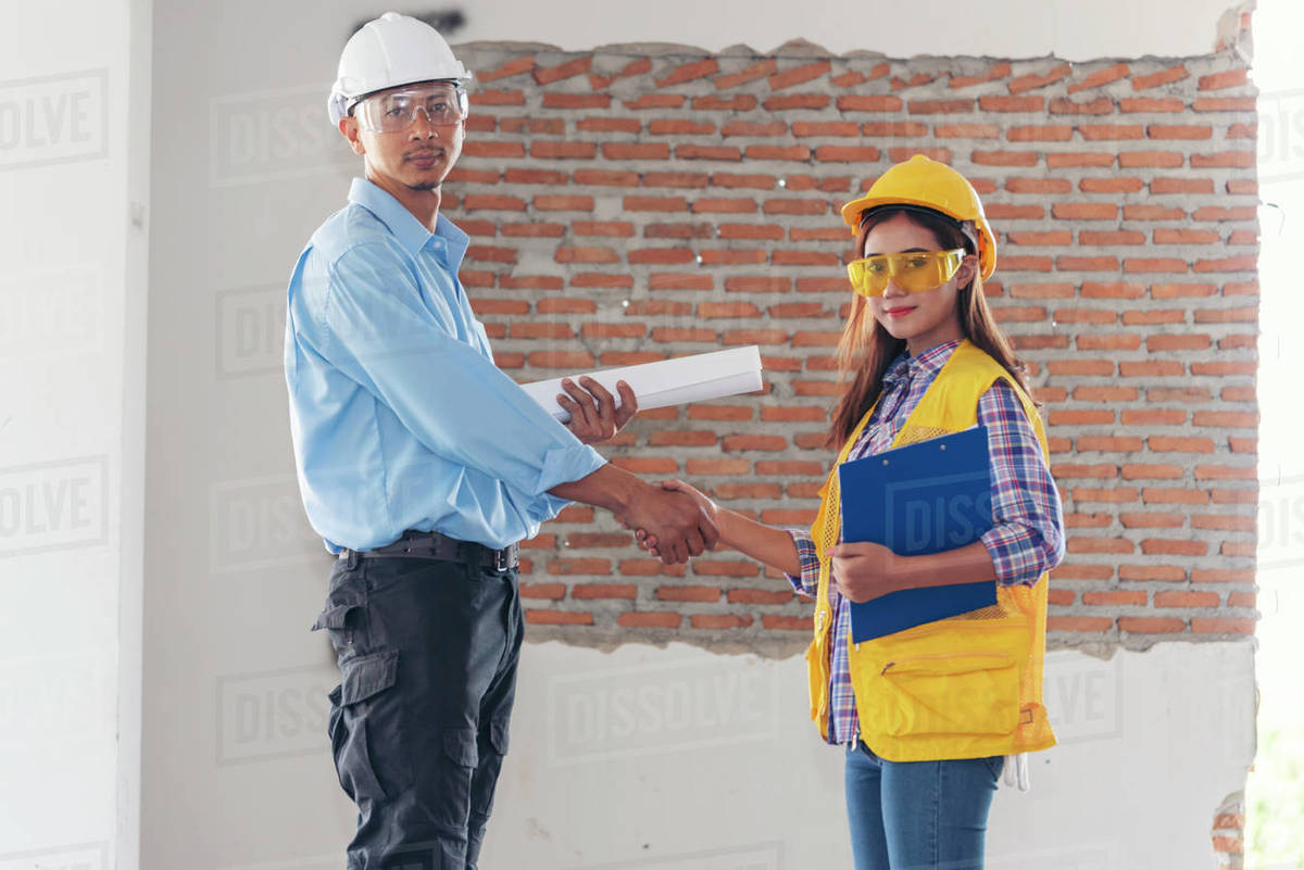 Civil Construction engineer teams shaking hands together wear work ...