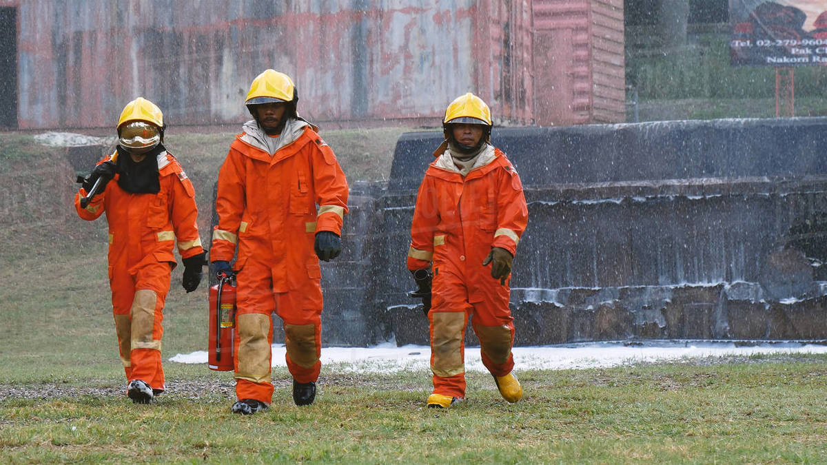 Firefighter fighting with flame using fire hose chemical water foam ...