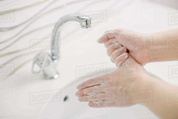 Woman washes her hands by surgical hand washing method. She washes his ...