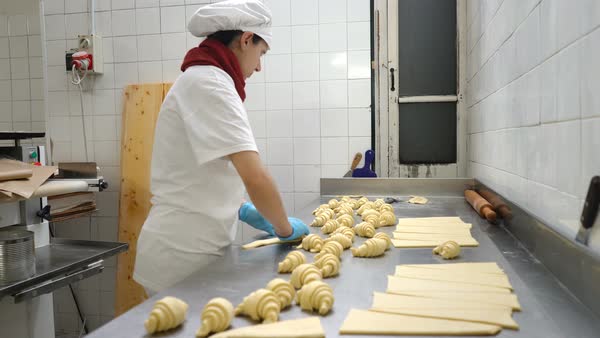 Traditional Italian family bakery. A female baker turns beautiful ...
