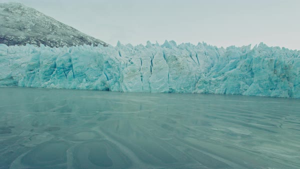 Cinematic aerial shot approaching the wall of a glacier. Colony glacier ...