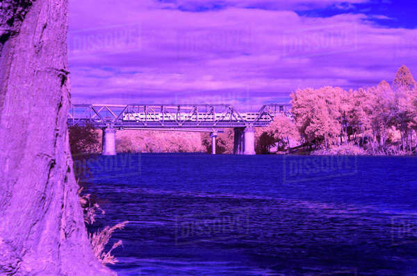 Infrared photograph of a commuter train on the Victoria Bridge crossing ...