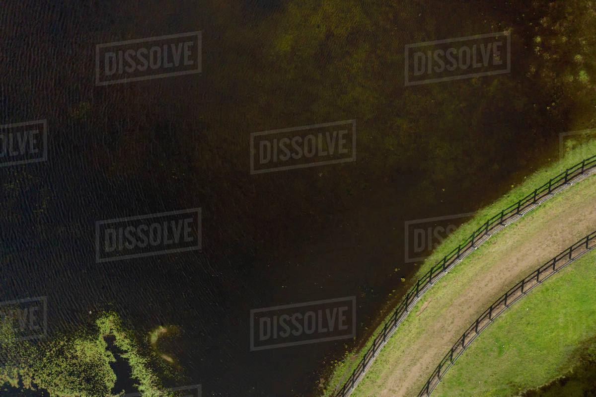 Aerial photograph of a horse trotting track near a fresh water lake in ...