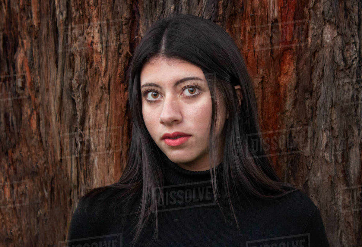 Portrait of beautiful girl with pine tree background - Stock Photo ...