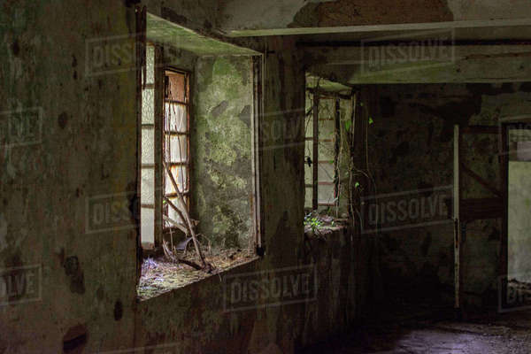 Old abandoned factory house windows in decay with broken glass and ...