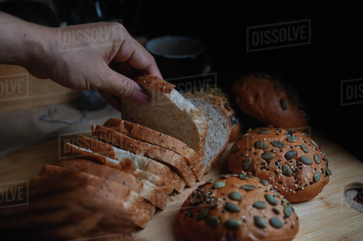 Hand of woman pick a wholewheat bread - Royalty-free Stock Photo | Dissolve