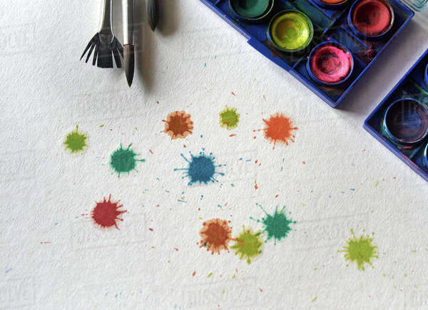 Paintbrushes with the color palettes and the color stains on the rough ...