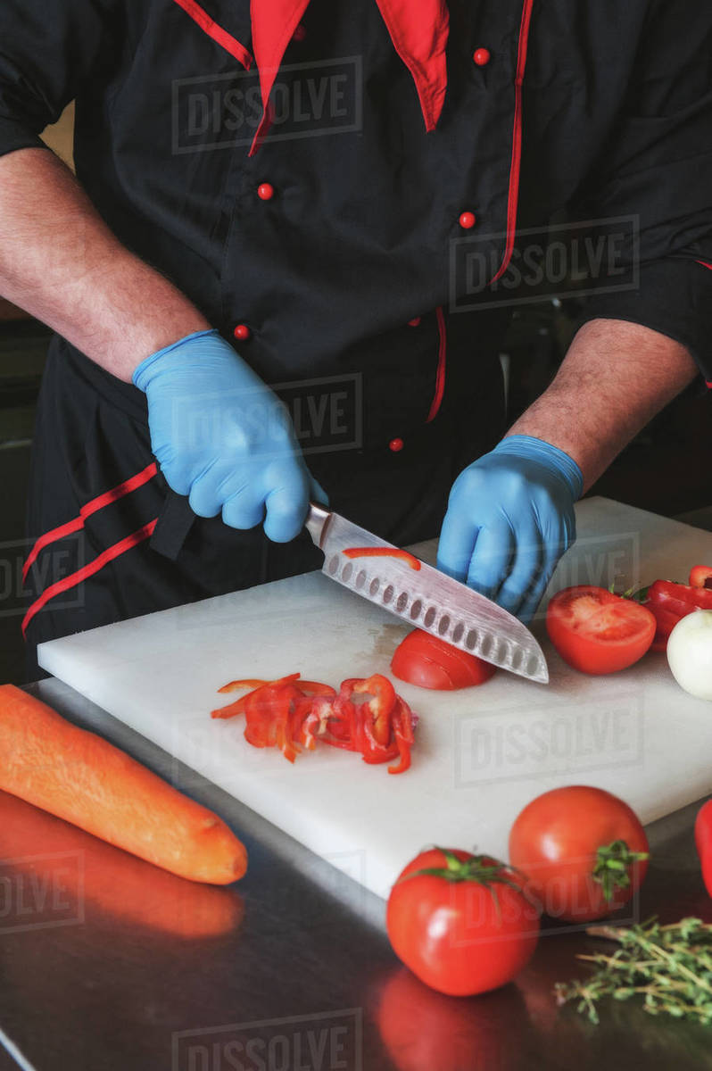 Chef cutting vegetables with knife - Stock Photo - Dissolve