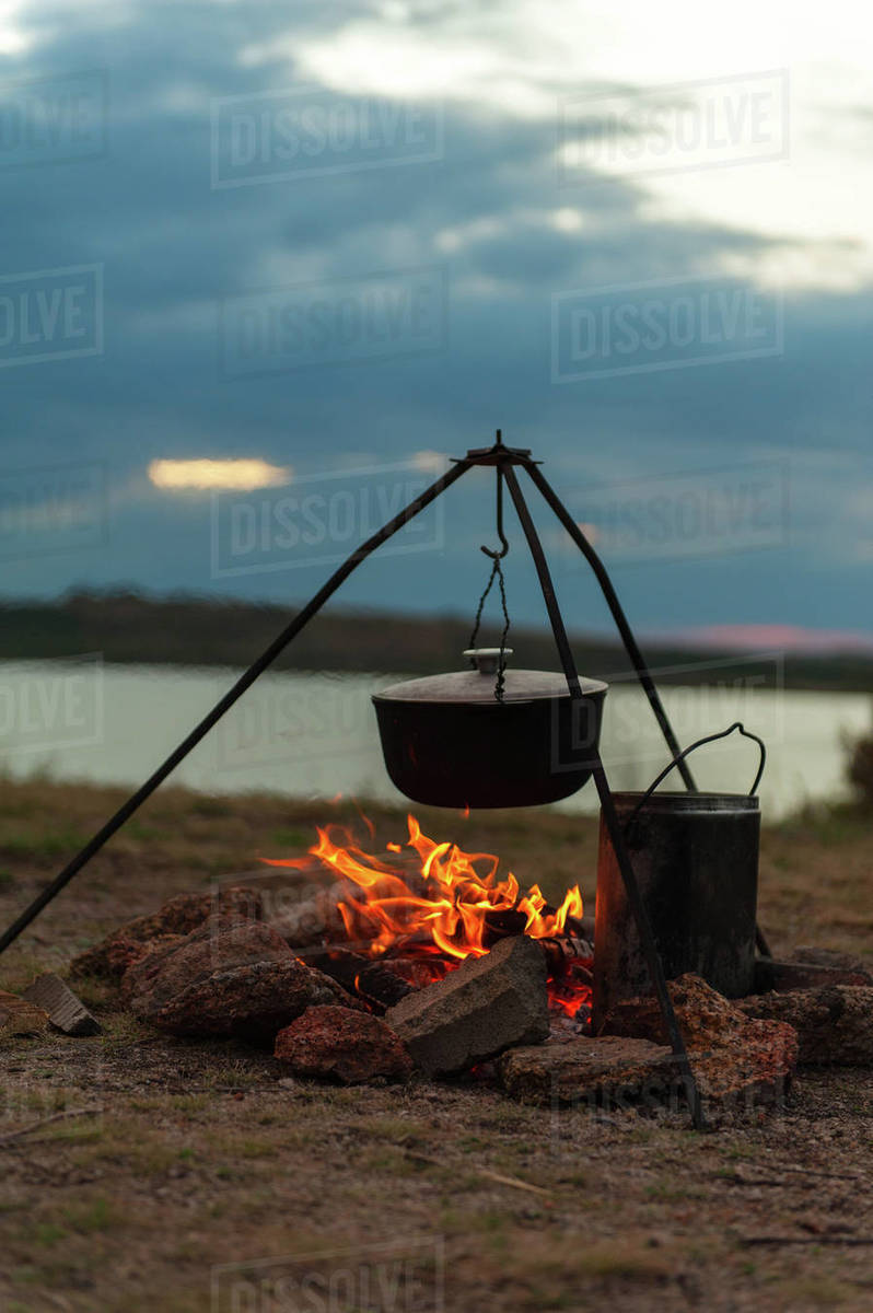 Preparing food on campfire in wild camping, resting on the nature ...