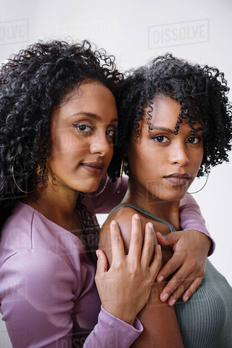 Portrait of two women of color hugging each other - Stock Photo - Dissolve