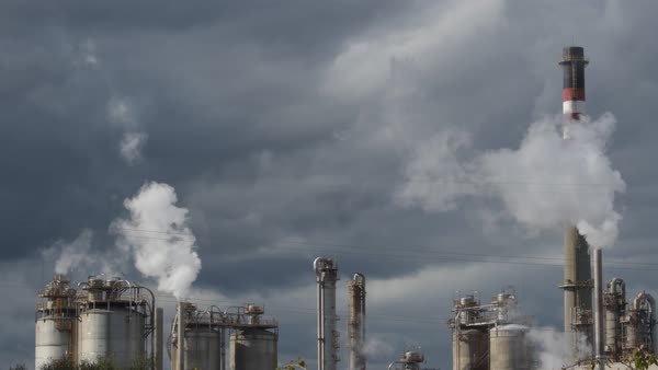 Industrial chimneys expelling smoke in a industrial factory a cloudy ...