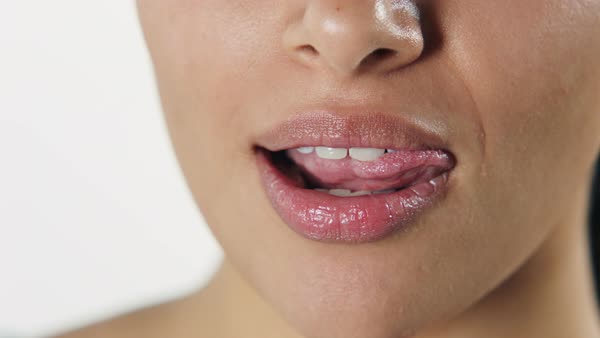 Woman licking her lips and biting her bottom lip. - 4K Royalty-free ...