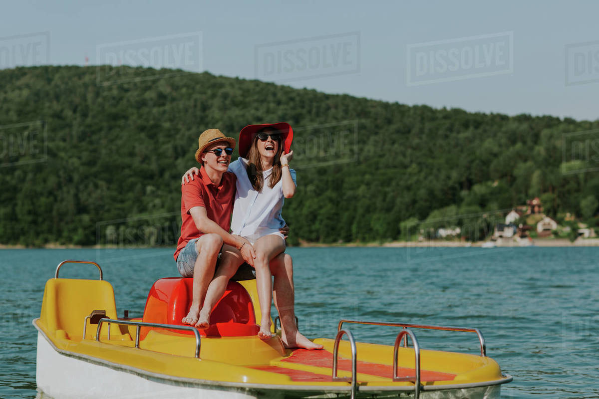 Couple in love laughing while boating in the lake. Portrait of young ...