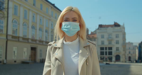 Beautiful blond Girl Wearing Medical Mask During Coronavirus in the ...