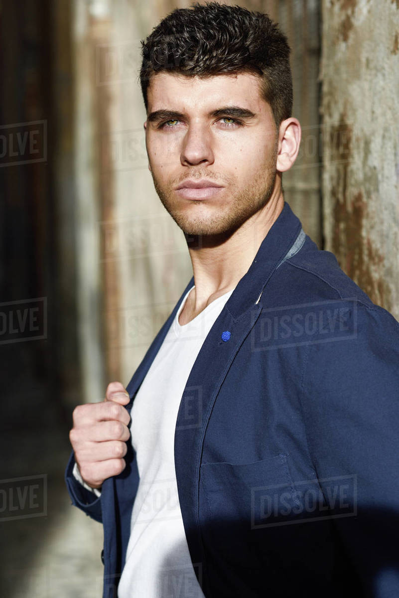 Good looking young man with blue eyes in the street. Model of fashion ...