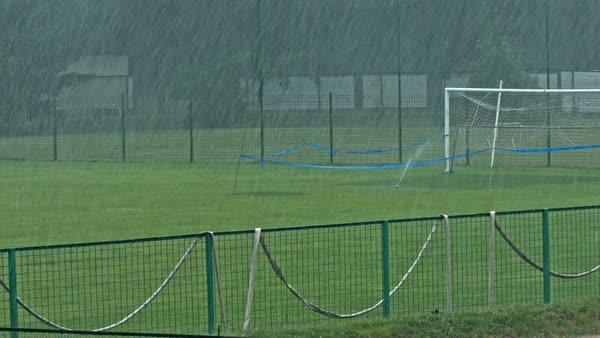 Summer rainfall hit the soccer field while being watered for quality ...