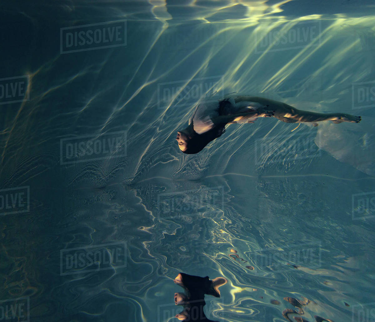 Underwater shoot of beautiful woman in white flying transparent dress ...