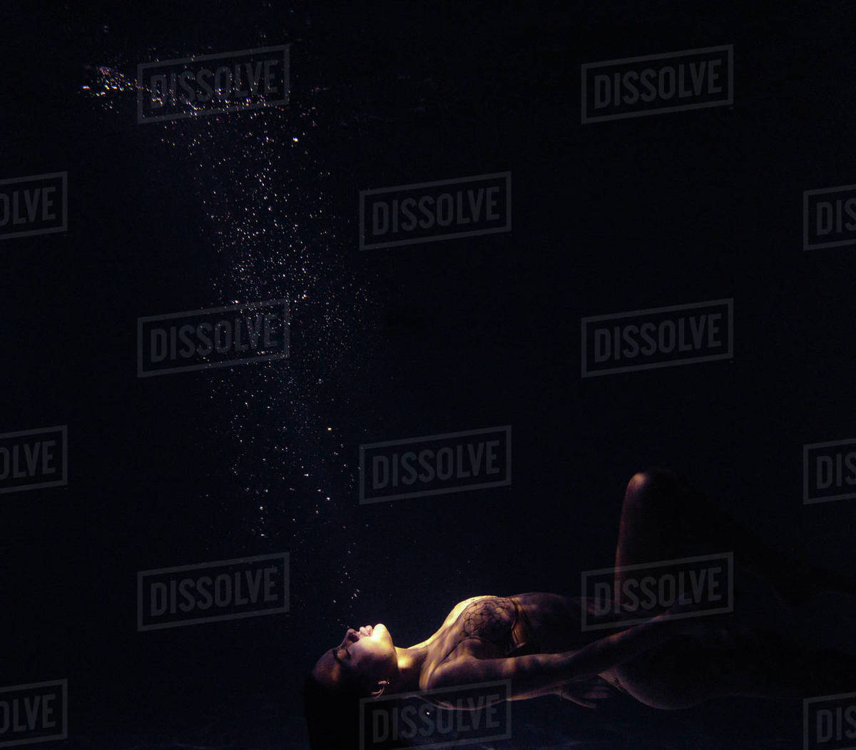 Underwater shoot of beautiful woman swimming and relaxing in water in ...