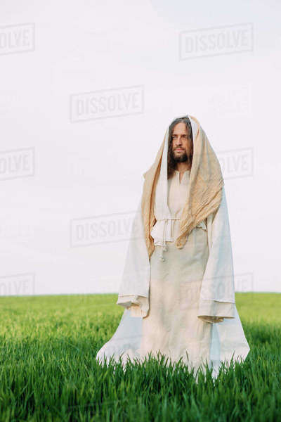 Prophet standing in meadow clothed in his traditional white robe ...