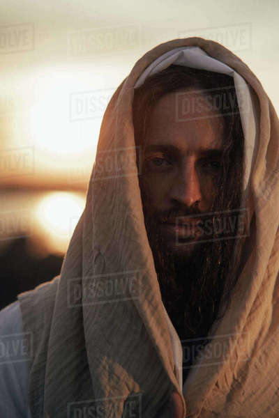 Prophet in his traditional white robe against sunset sky background ...