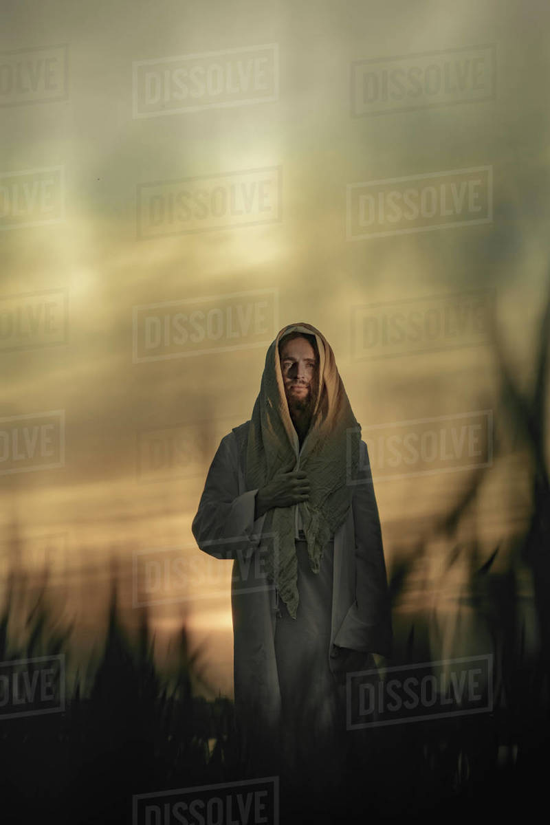 Prophet walks in meadow clothed in his traditional white robe against ...