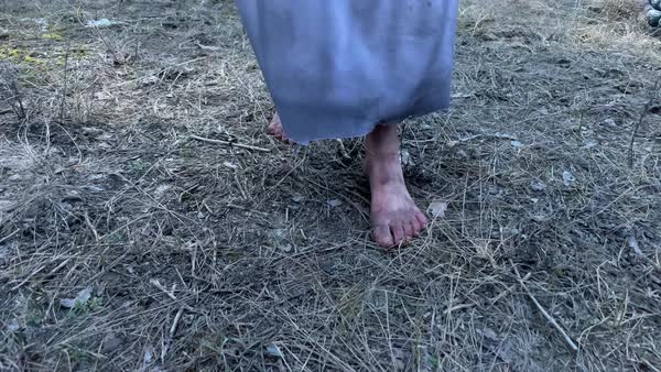 Girl in image of scary ghost zombie steps barefoot on needles in forest ...