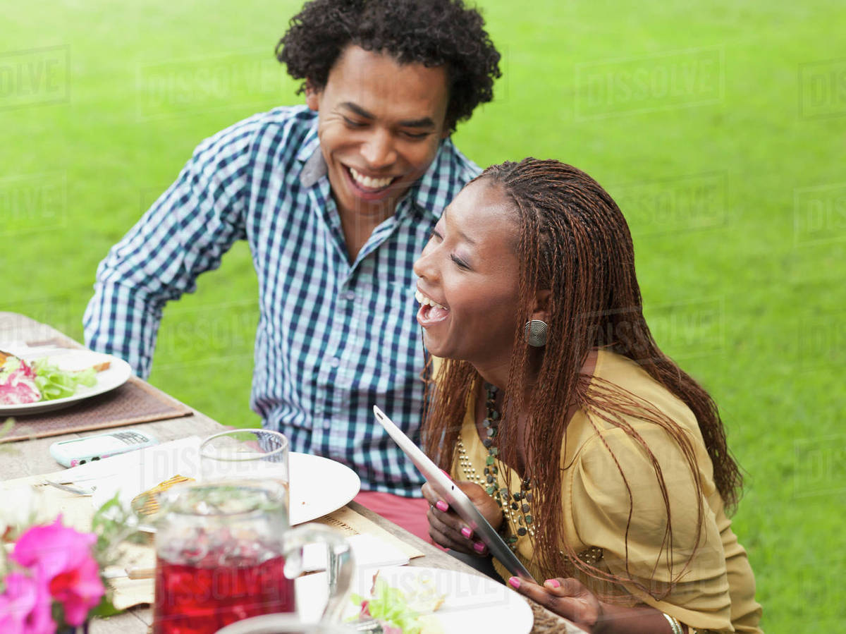 Three friends laughing at the lunch table - Royalty-free Stock Photo ...