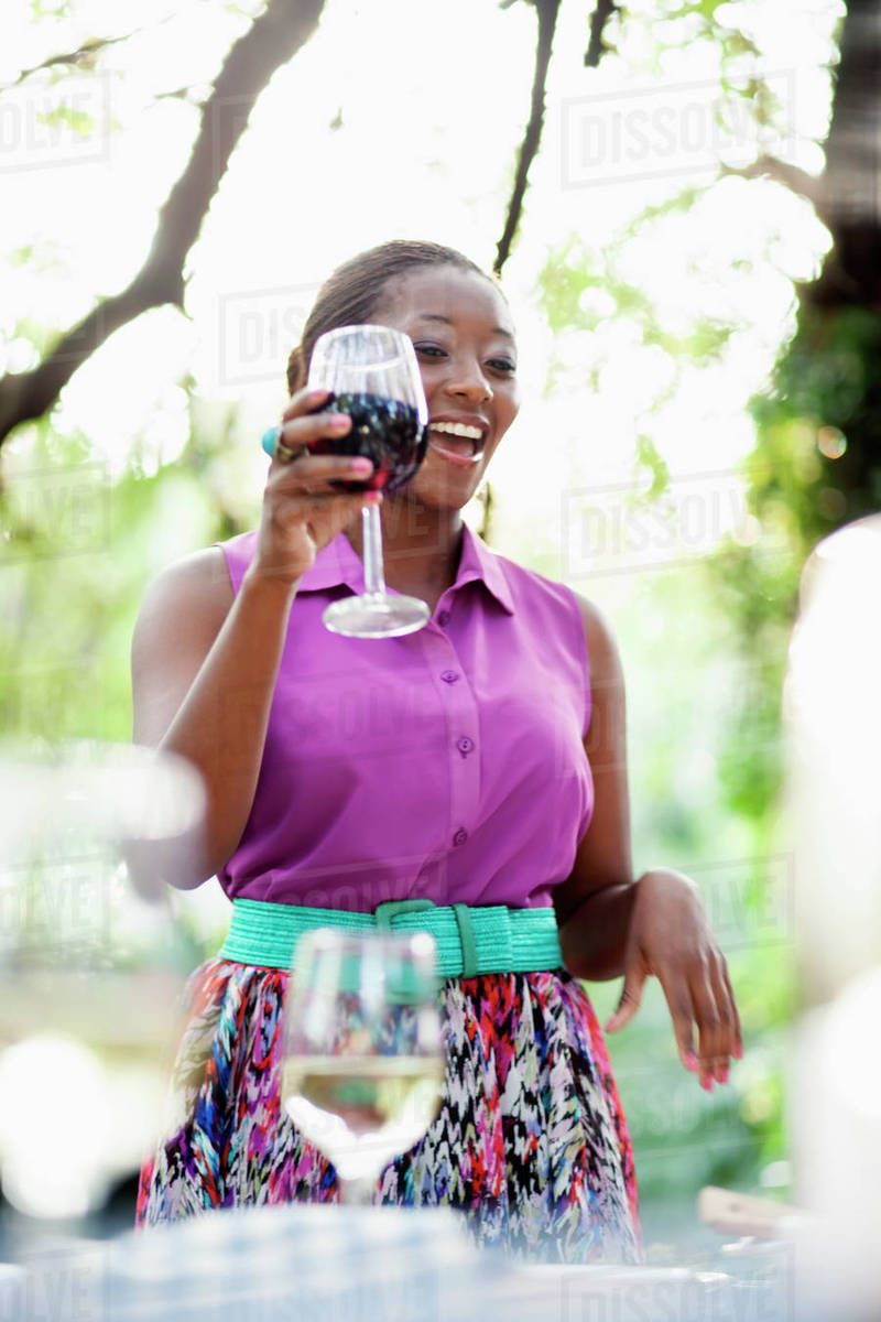 Woman standing up and giving a toast - Royalty-free Stock Photo | Dissolve