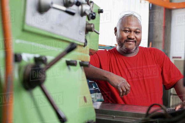 African man operating a machine at a warehouse - Royalty-free Stock ...