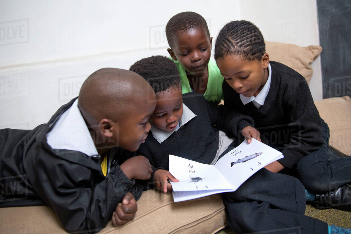 School kids reading in the classroom - Royalty-free Stock Photo | Dissolve