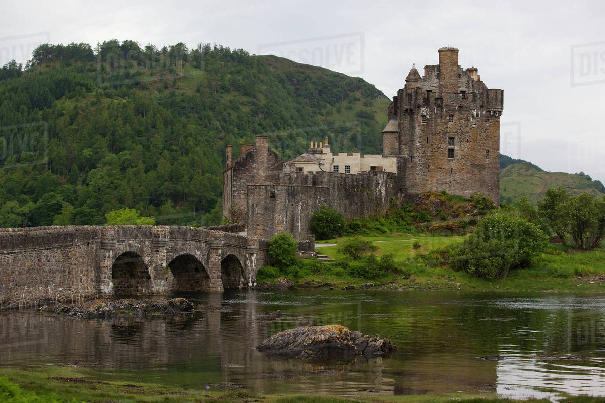 Scottish castle and arched road bridge - Stock Photo - Dissolve