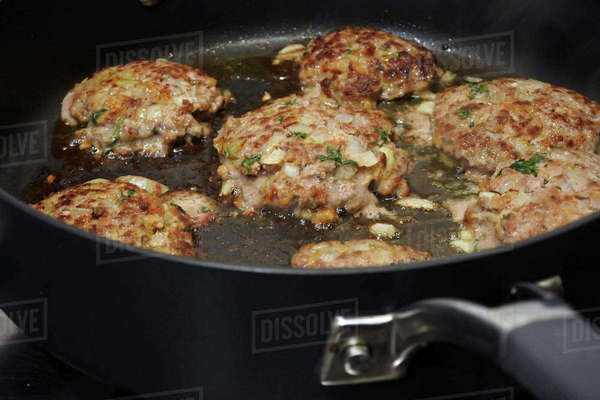 Frying beef meat patties in a fry pan. Food background and texture ...