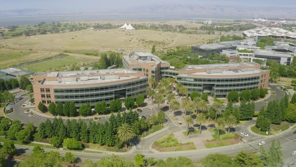 Google Headquarters complex, surrounded by lush green vegetation ...