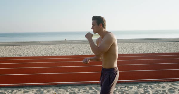 Man boxer exercising at stadium. Handsome sport man running and boxing ...