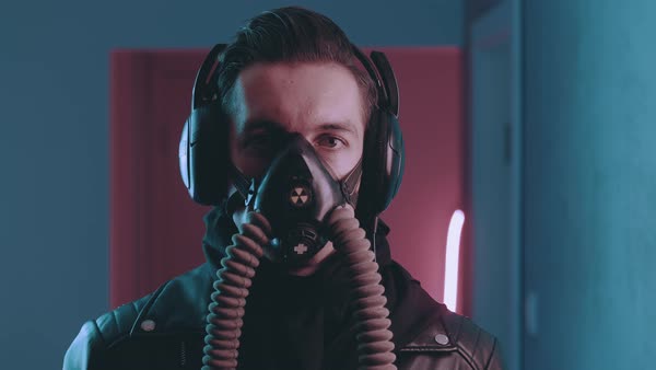 Cyberpunk portrait of brutal man in respirator listening to music with ...