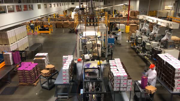Good time lapse footage of workers inside an American factory or ...