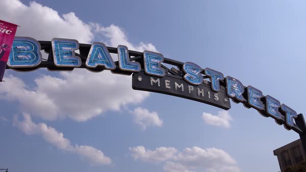Time lapse shot of clouds moving behind Beale Street Memphis arch sign ...