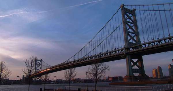 A commuter train crosses the Ben Franklin Bridge near Philadelphia, PA ...