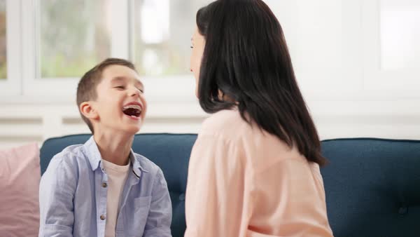 Close-up of mom and son laughing and having fun together, bonding ...