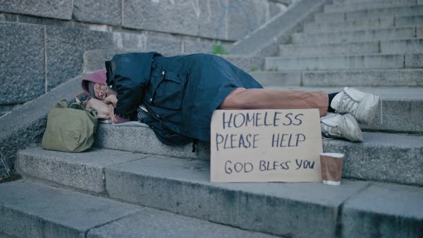 Aged homeless man sleeping on the stairs near cardboard sign, social ...