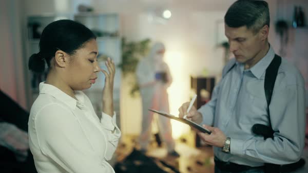 Shocked woman talking to detective at crime scene, witness, murder ...