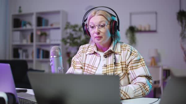 Woman in her 50s streaming video game, gamer vlogging, e-sports ...