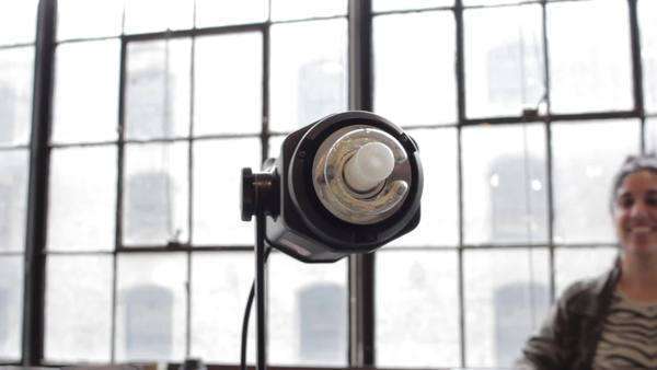 Locked off shot of a woman installing lighting equipment - HD Royalty ...