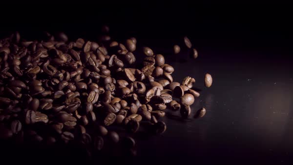 Roasted Coffee Beans falling onto Black Background made of stone. Super ...