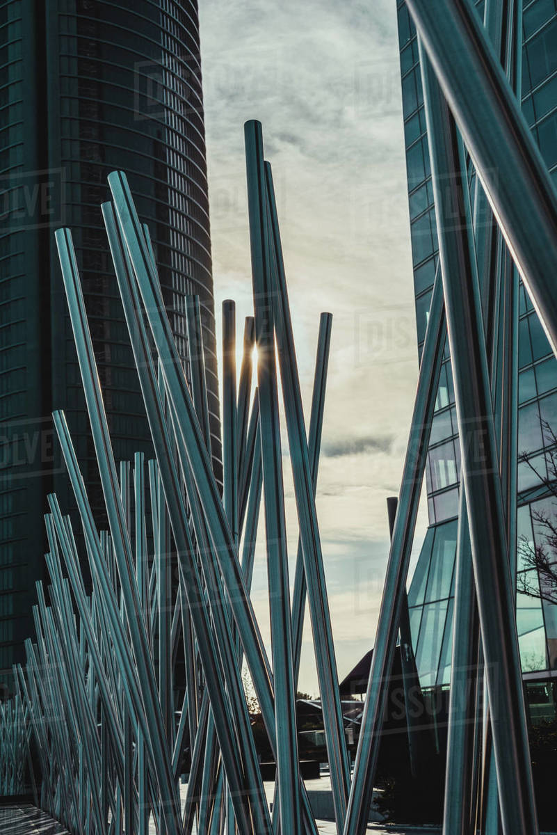Steel rods with buildings and the sun in the background. - Stock Photo ...